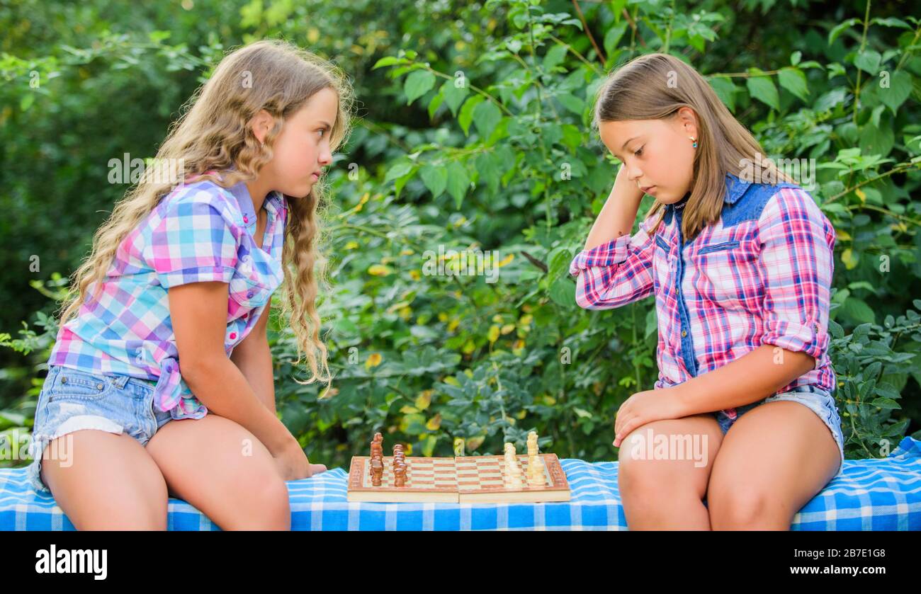Think better. Little girls play chess. Sisters playing chess. Smart ...