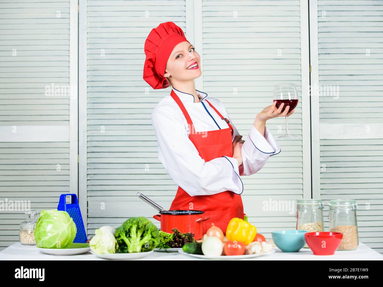 Housekeeping and culinary. Housewife prepare meal with wine. Housewife ...