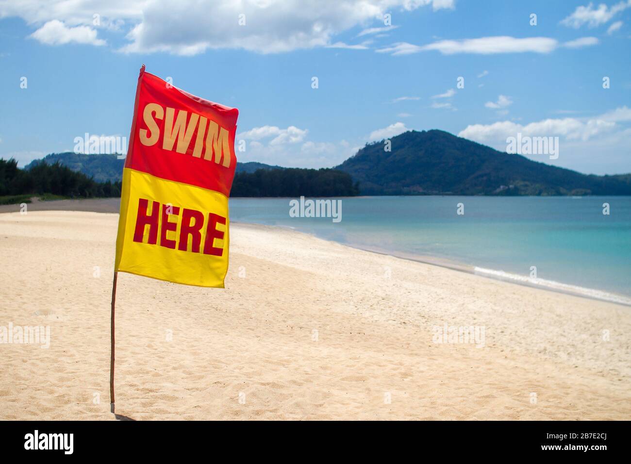 red and yellow flag with text swim here on the sea beach Stock Photo ...