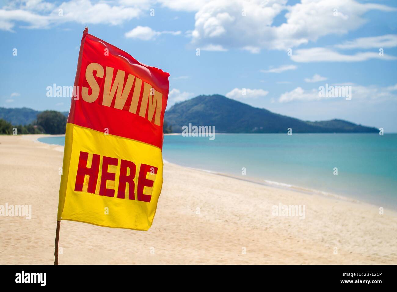 red and yellow flag with text swim here on the sea beach Stock Photo ...