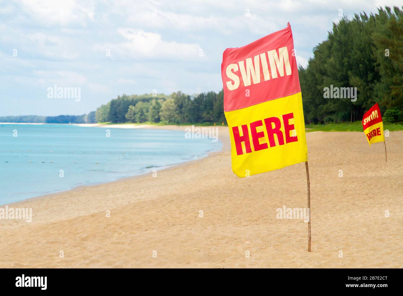 red and yellow flag with text swim here on the sea beach Stock Photo ...