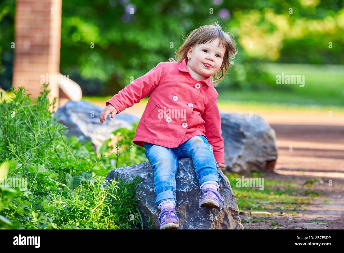 Happy little girl having fun Stock Photo - Alamy