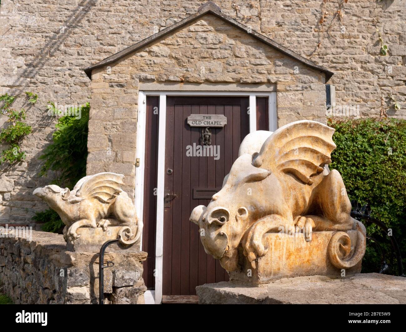 Gargoyles on gate posts Stock Photo - Alamy