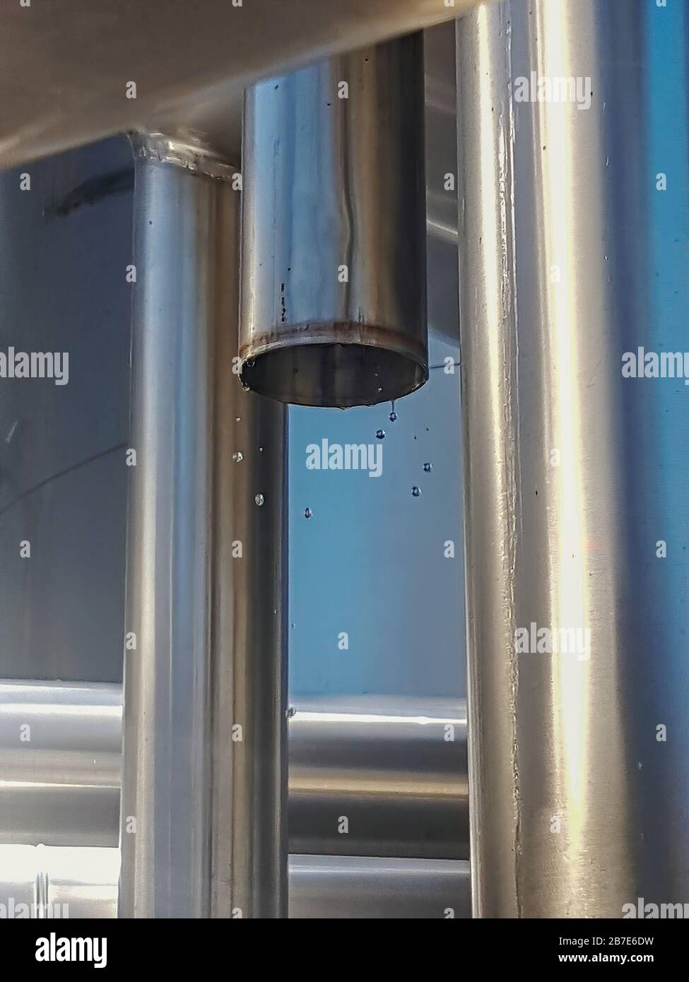 large aluminum pipes dropping water drops Stock Photo - Alamy
