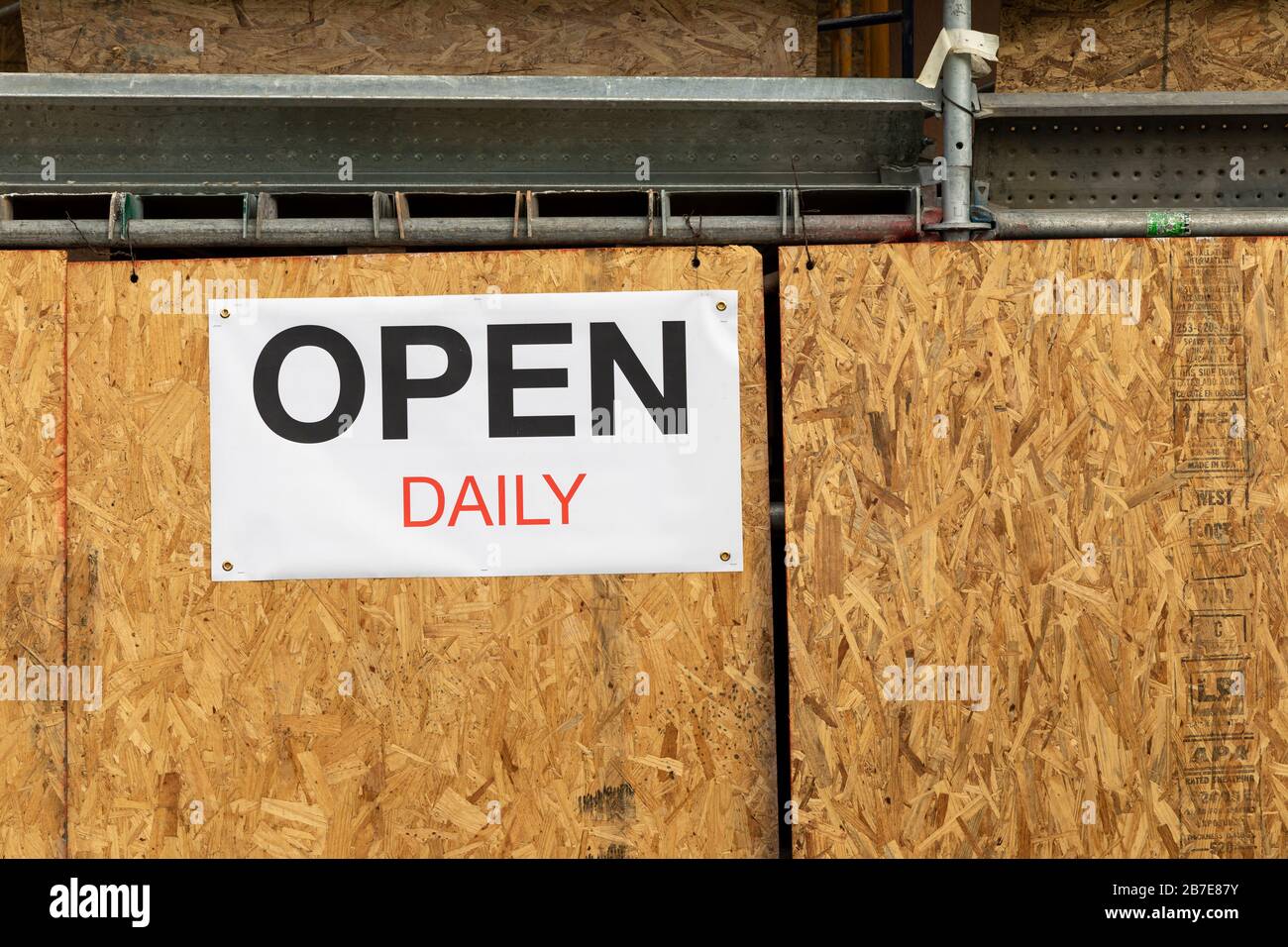 "Open daily" sign on scaffolding, chipboard background Stock Photo - Alamy
