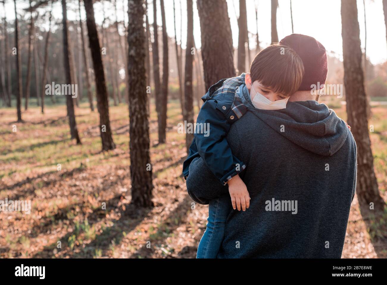 Concerned father and son using air protection masks Stock Photo - Alamy