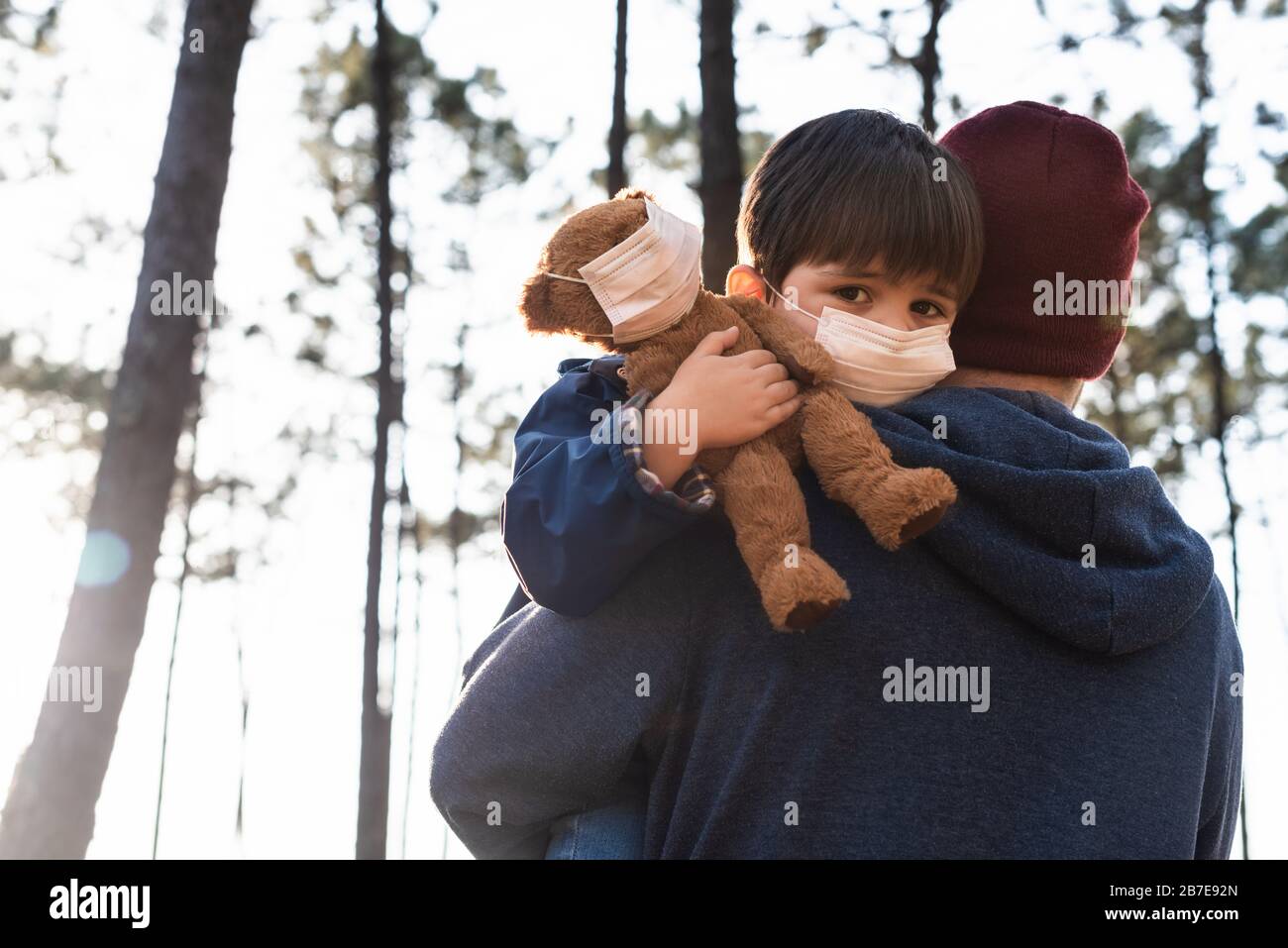 Concerned father and son using air protection masks Stock Photo - Alamy