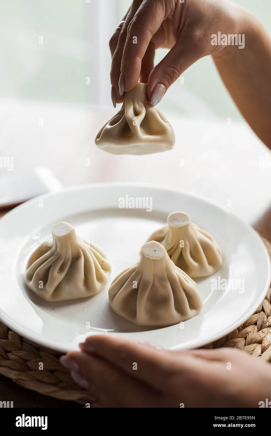 Woman hold khinkali in hand hi-res stock photography and images - Alamy
