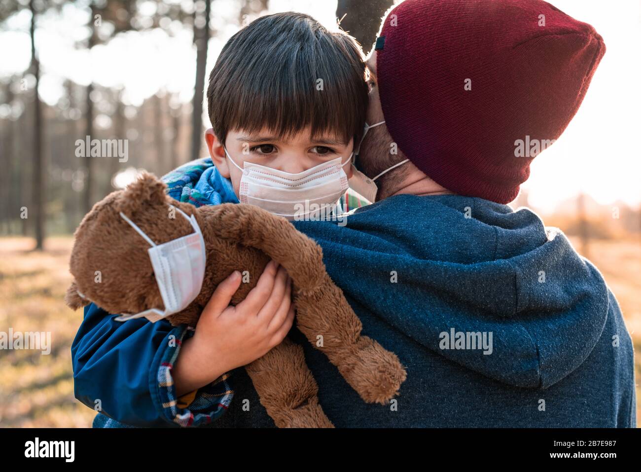 Concerned father and son using air protection masks Stock Photo - Alamy