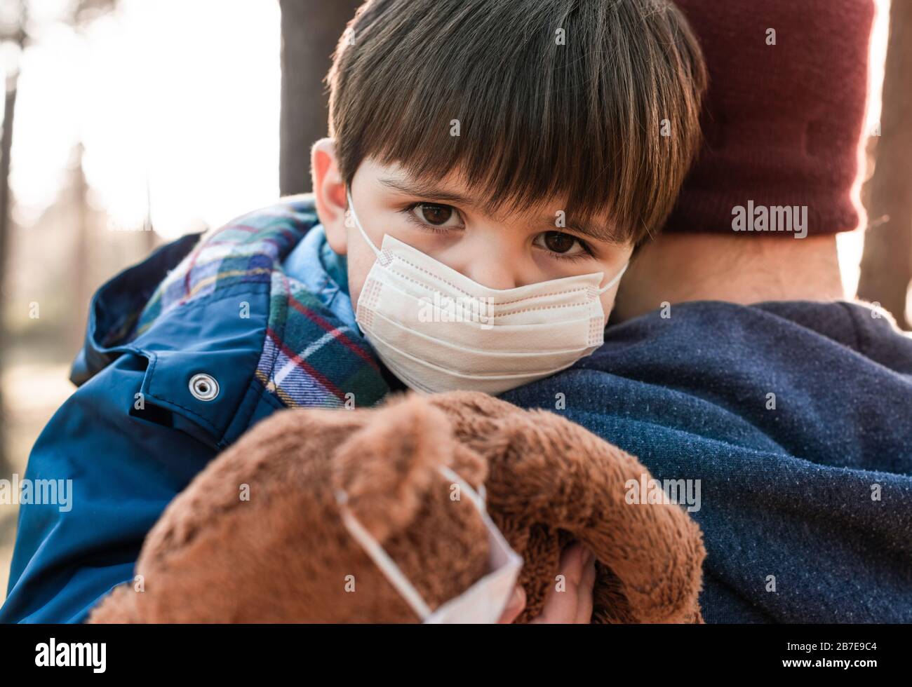 Concerned father and son using air protection masks Stock Photo - Alamy