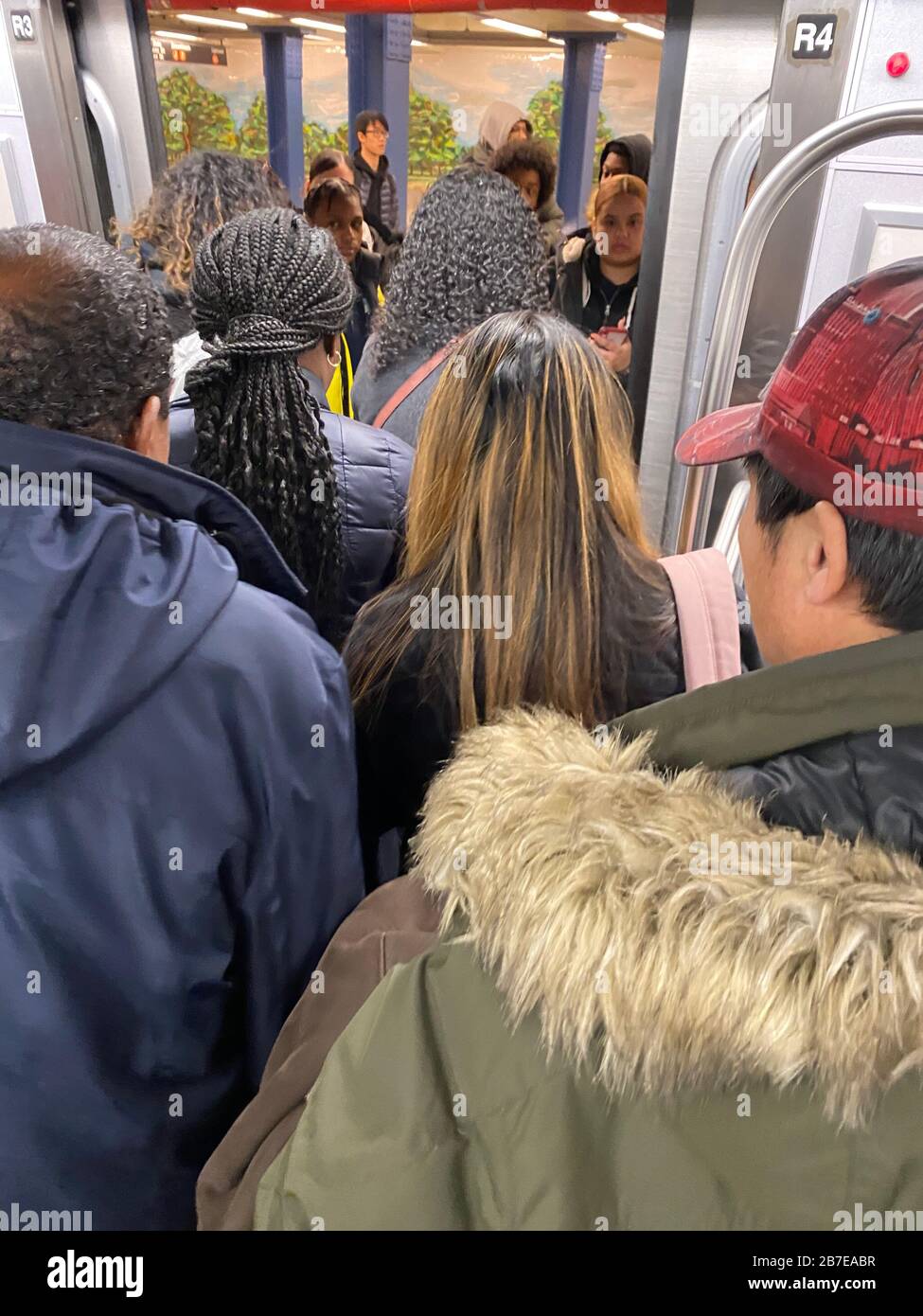 Riders exit a very crowded subway train in Manhattan during the morning ...
