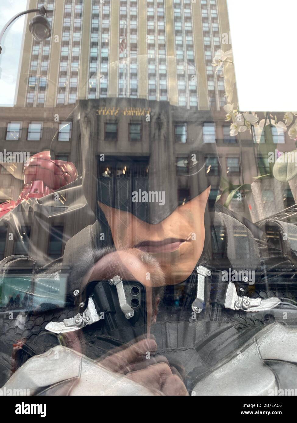 Batman with reflections in a store window along 5th Avenue in New York ...