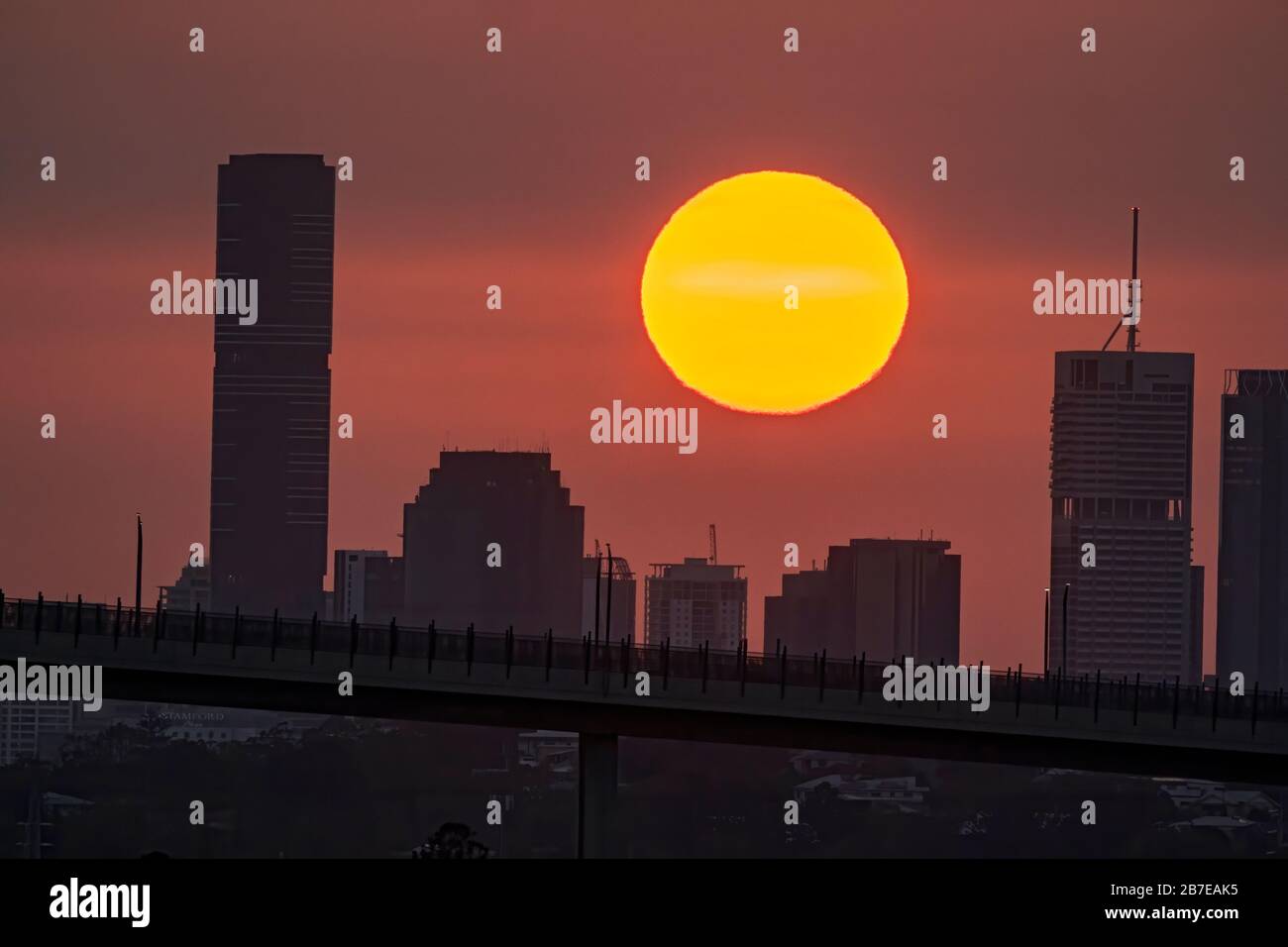 view of city of Brisbane, Australia, at sunset, showing sun setting ...
