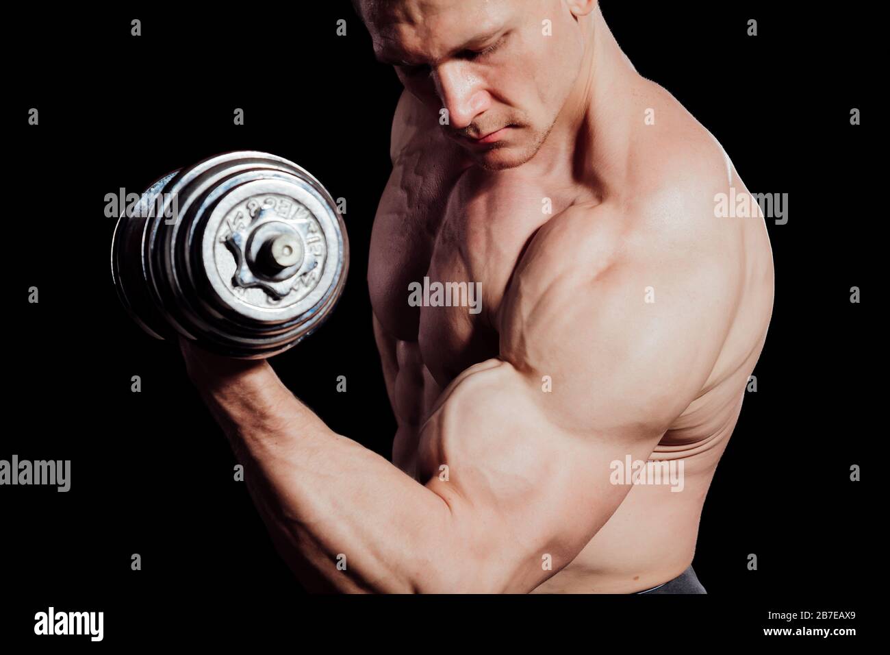 male man bodybuilder with dumbbells power workout Stock Photo - Alamy