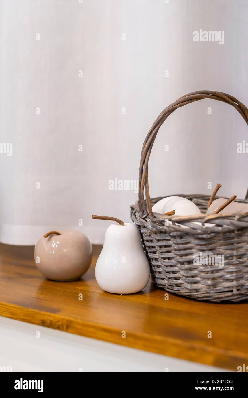 Still life - a basket of porcelain ceramic fruits in neutral colors on ...