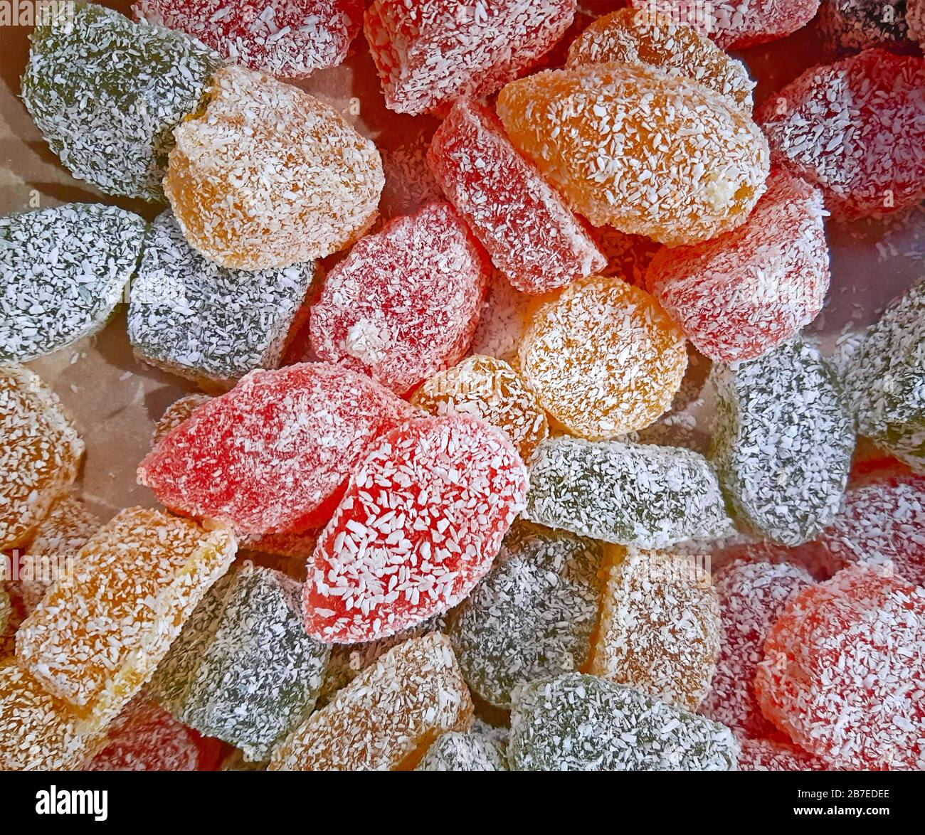 Marmalade in bulk coconut flakes, background Stock Photo - Alamy