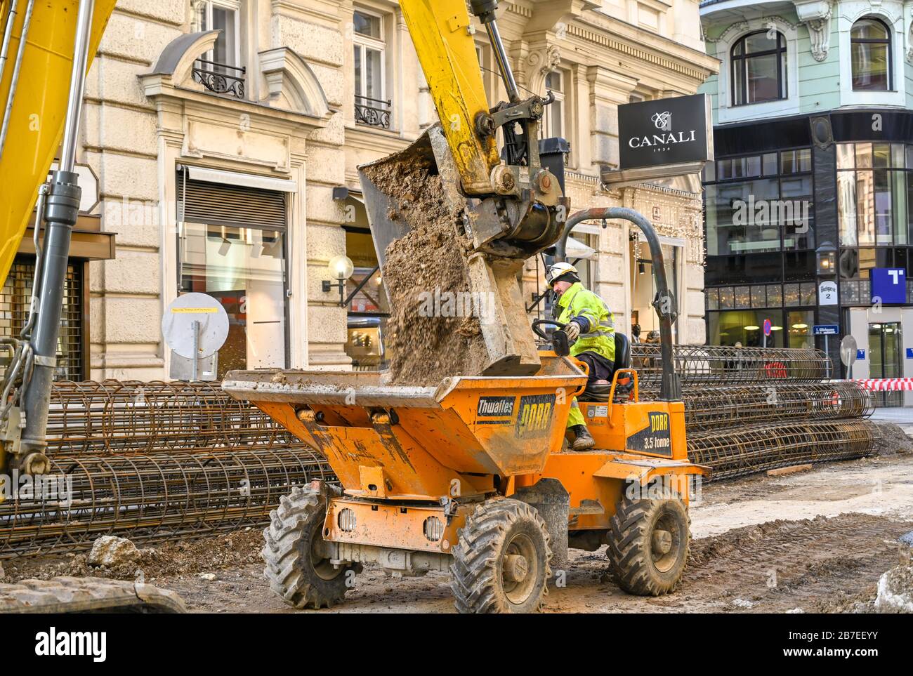 VIENNA, AUSTRIA - NOVEMBER 2019: An excavator tipping soil into a ...