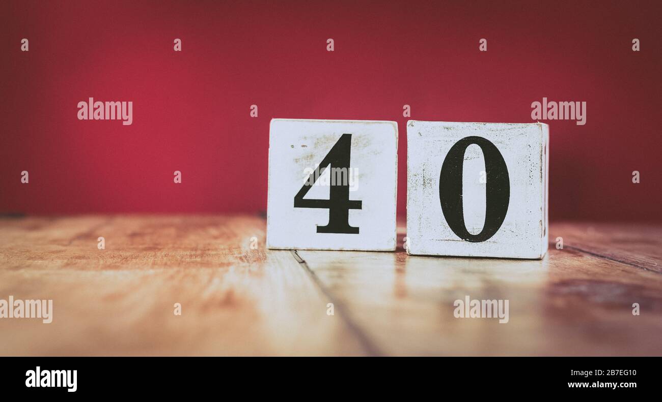 Number 40 on a vintage wooden table and dark maroon background - retro ...