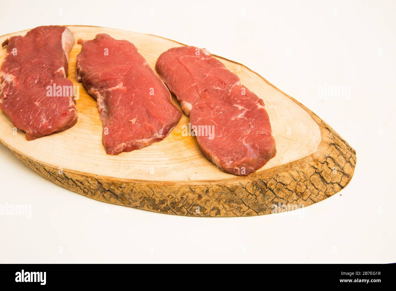Raw meat on board Stock Photo - Alamy