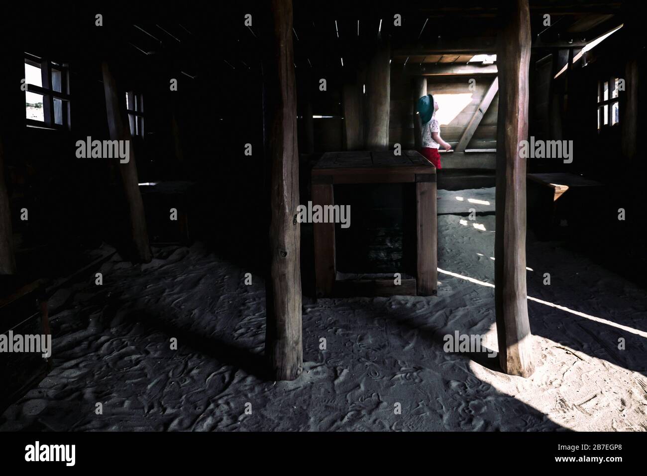 Kid in a dark room with wooden walls and columns Stock Photo - Alamy