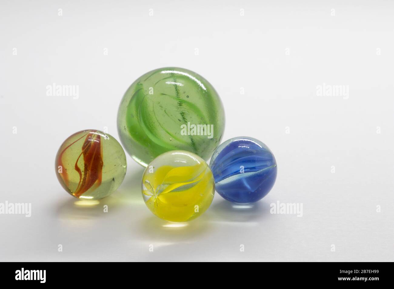 Colourful toy marbles against a white background Stock Photo - Alamy