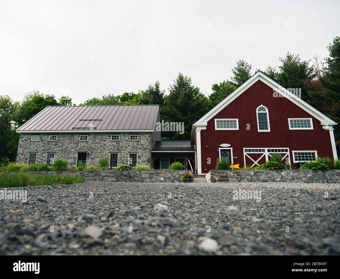 Low angle shot of a modern stone house connected to a barn house with ...