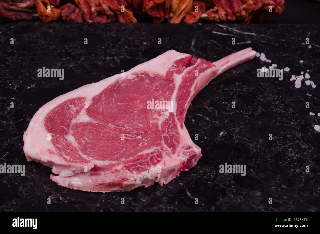 Raw meat on board Stock Photo - Alamy