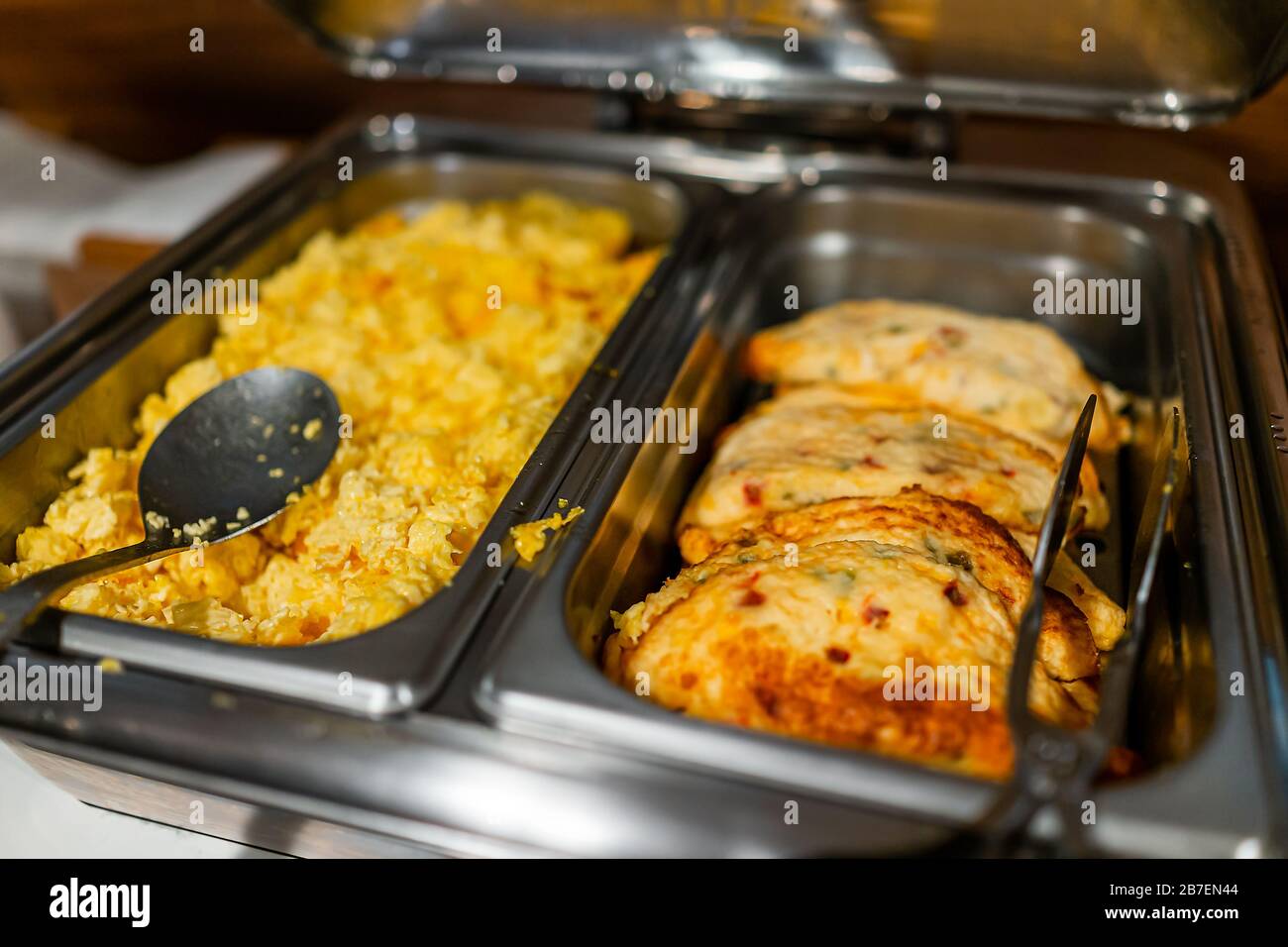 Fresh hot buffet tray with spoon to serve food scrambled eggs omelette ...