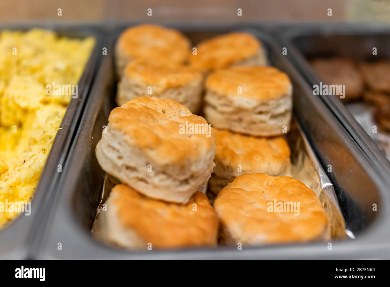Fresh buffet tray macro closeup with food scrambled eggs, biscuits in ...