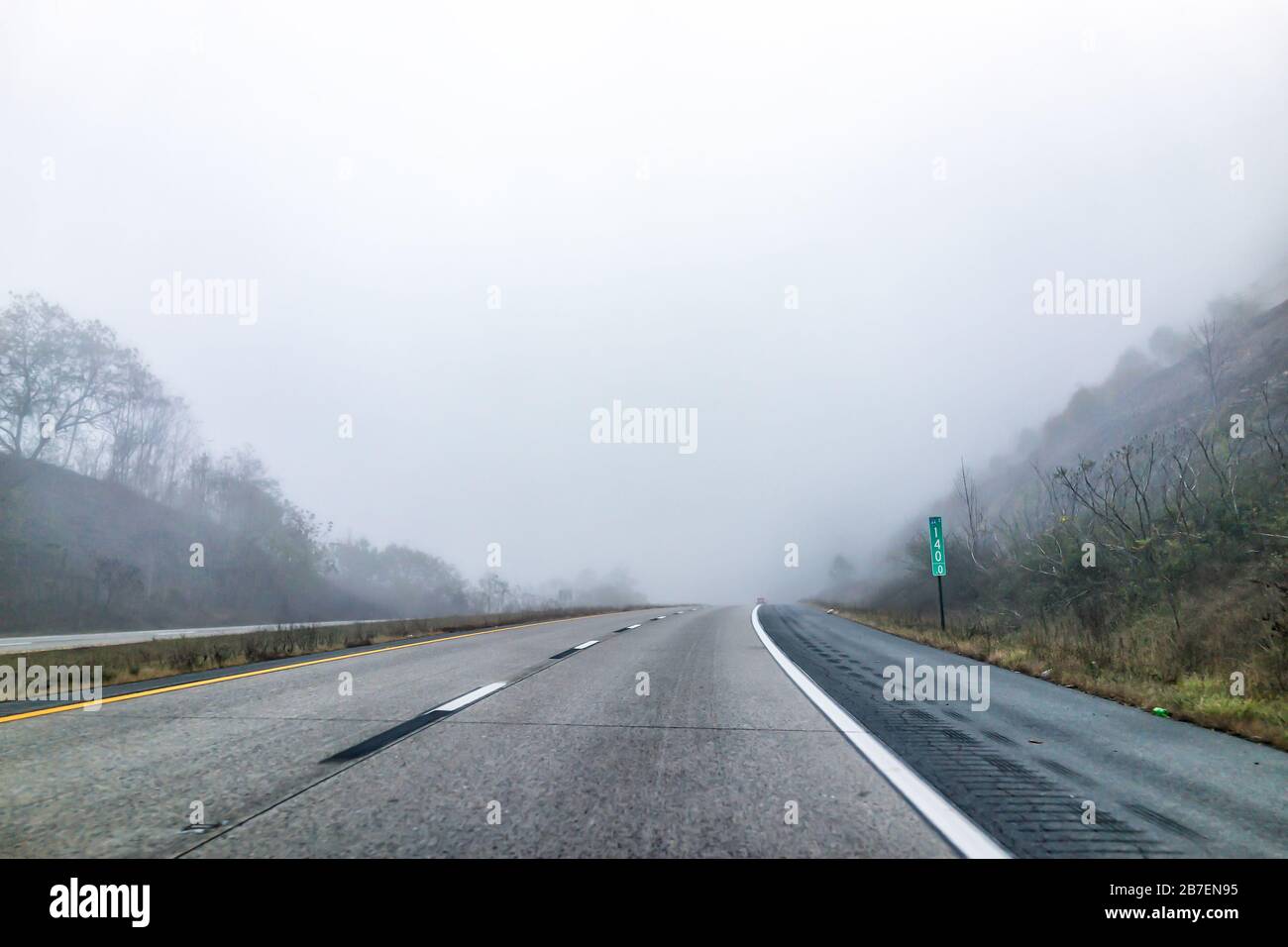 Fog mist road highway driving in rural countryside in West Virginia ...
