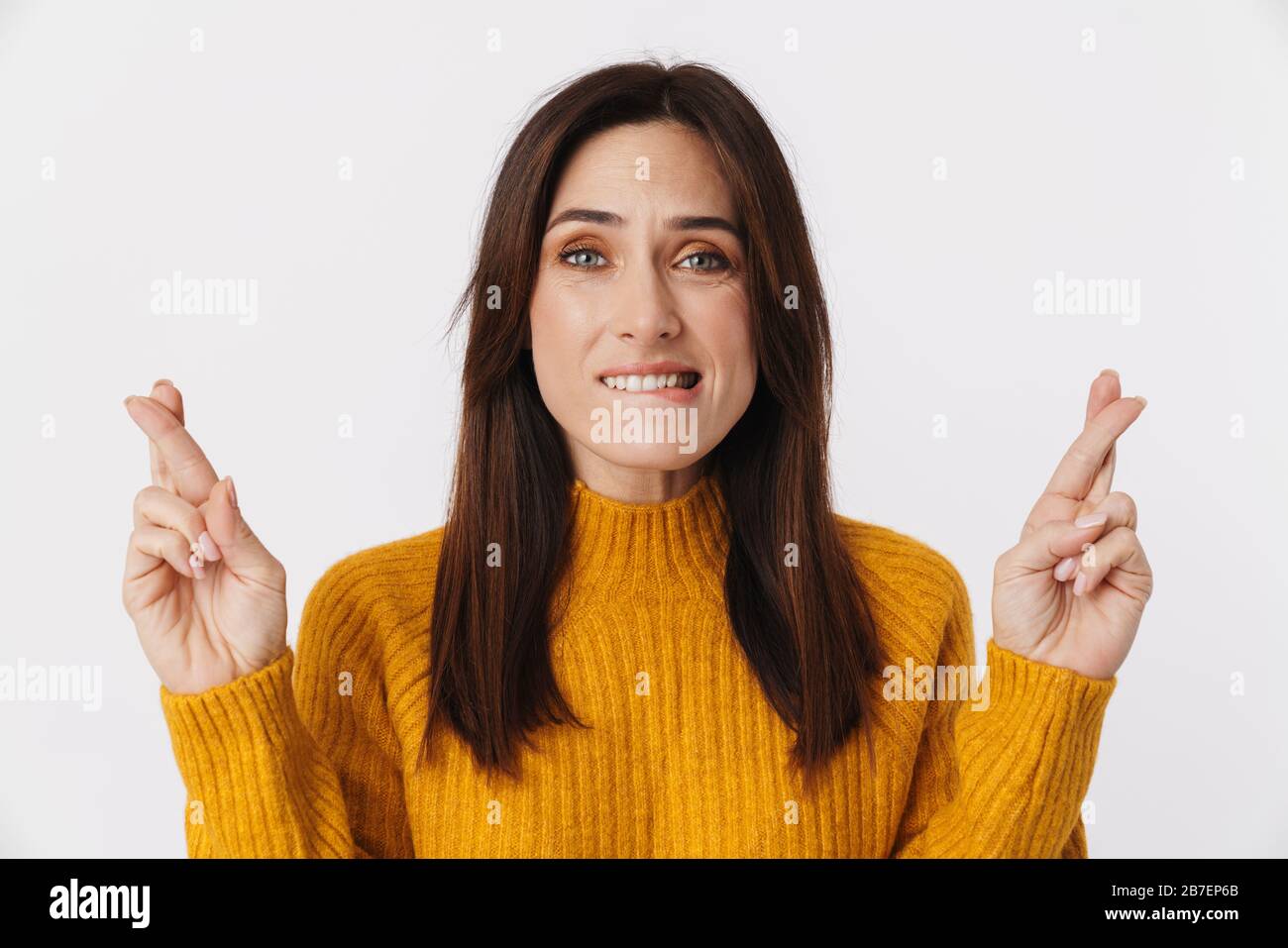 Image of beautiful brunette adult woman wearing sweater keeping fingers ...