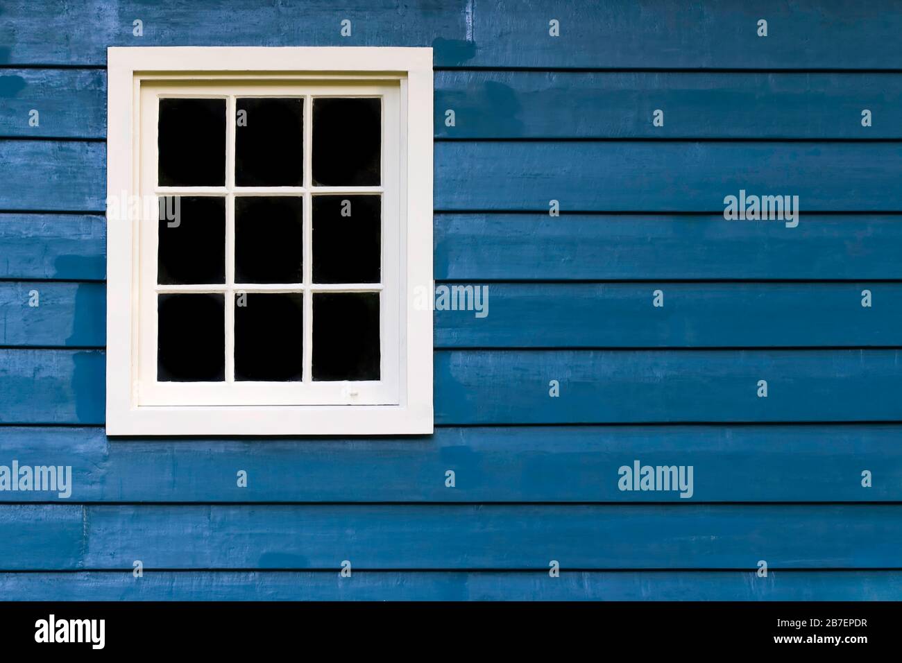 Multi pane window in a blue wooden house Stock Photo - Alamy