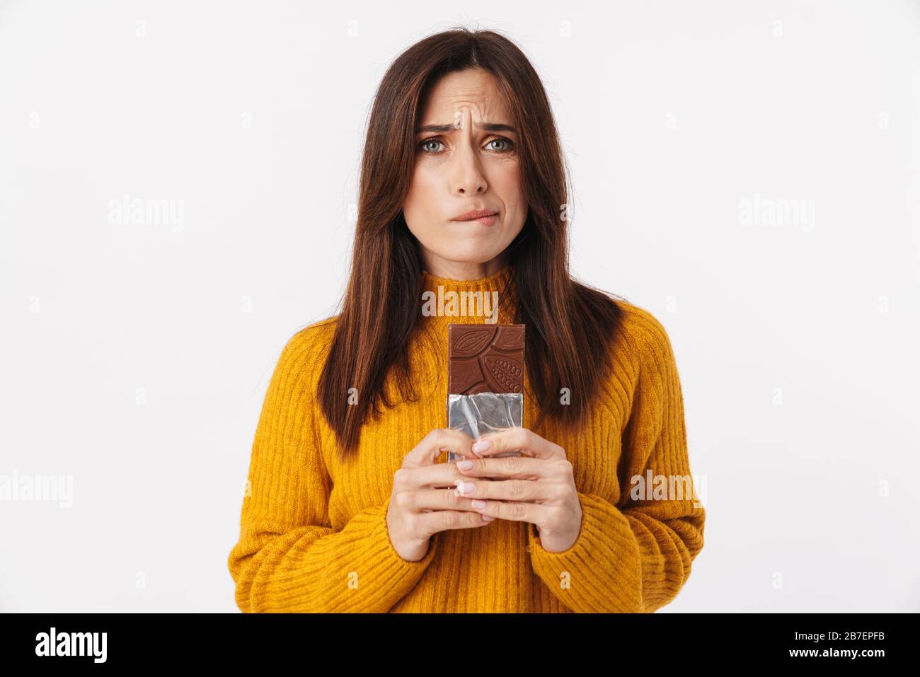 Image of beautiful brunette adult woman hesitating while holding ...