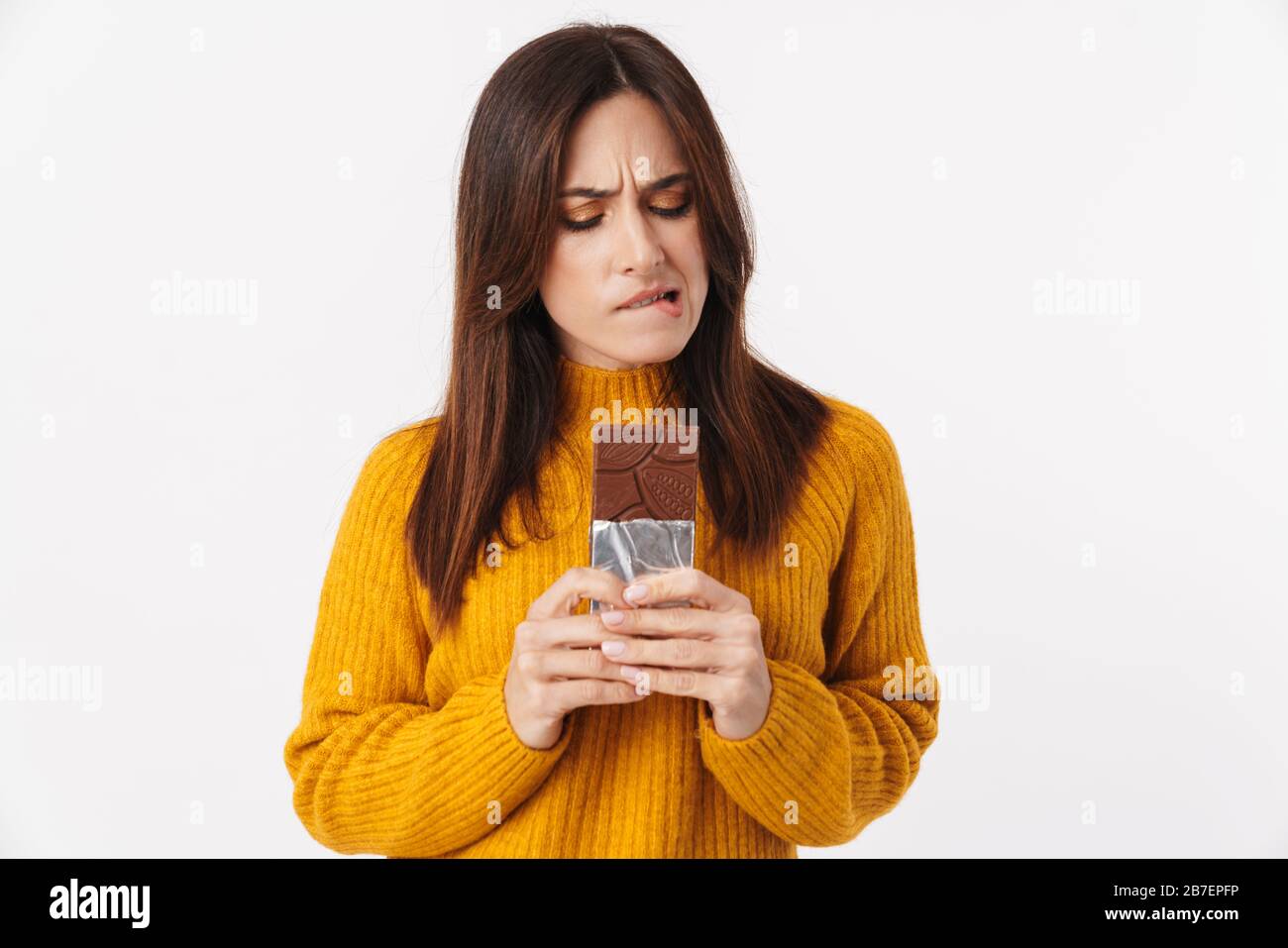 Image of beautiful brunette adult woman hesitating while holding ...