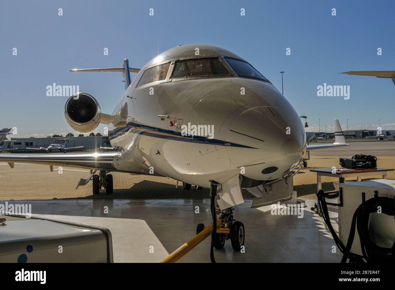 Bombardier Challenger 206 executive jet on the tarmac near a hangar ...
