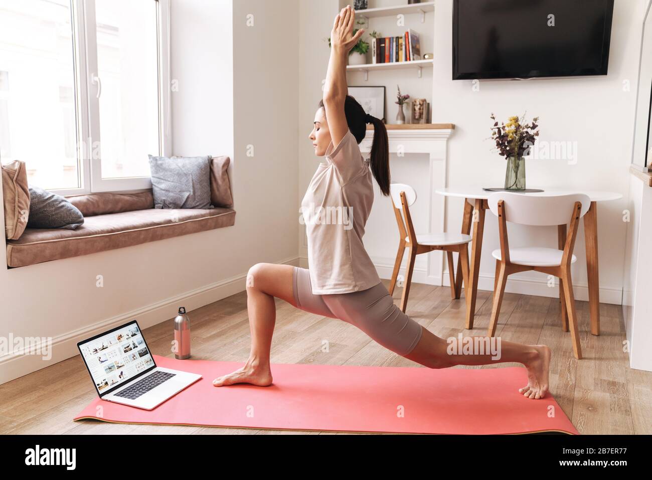 Image of a pretty young brunette fitness woman make stretching ...