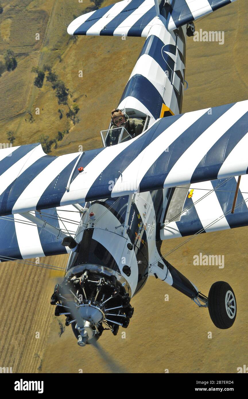 An aerial view of a WWII Boeing Stearman biplane pilot trainer in black ...