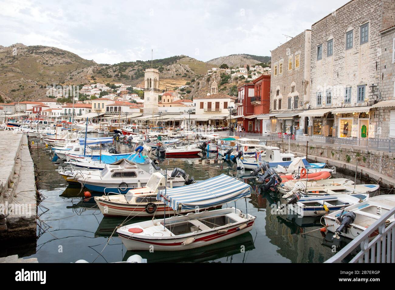Greek fishing boats anchored along the promenade in the Agean seaport ...