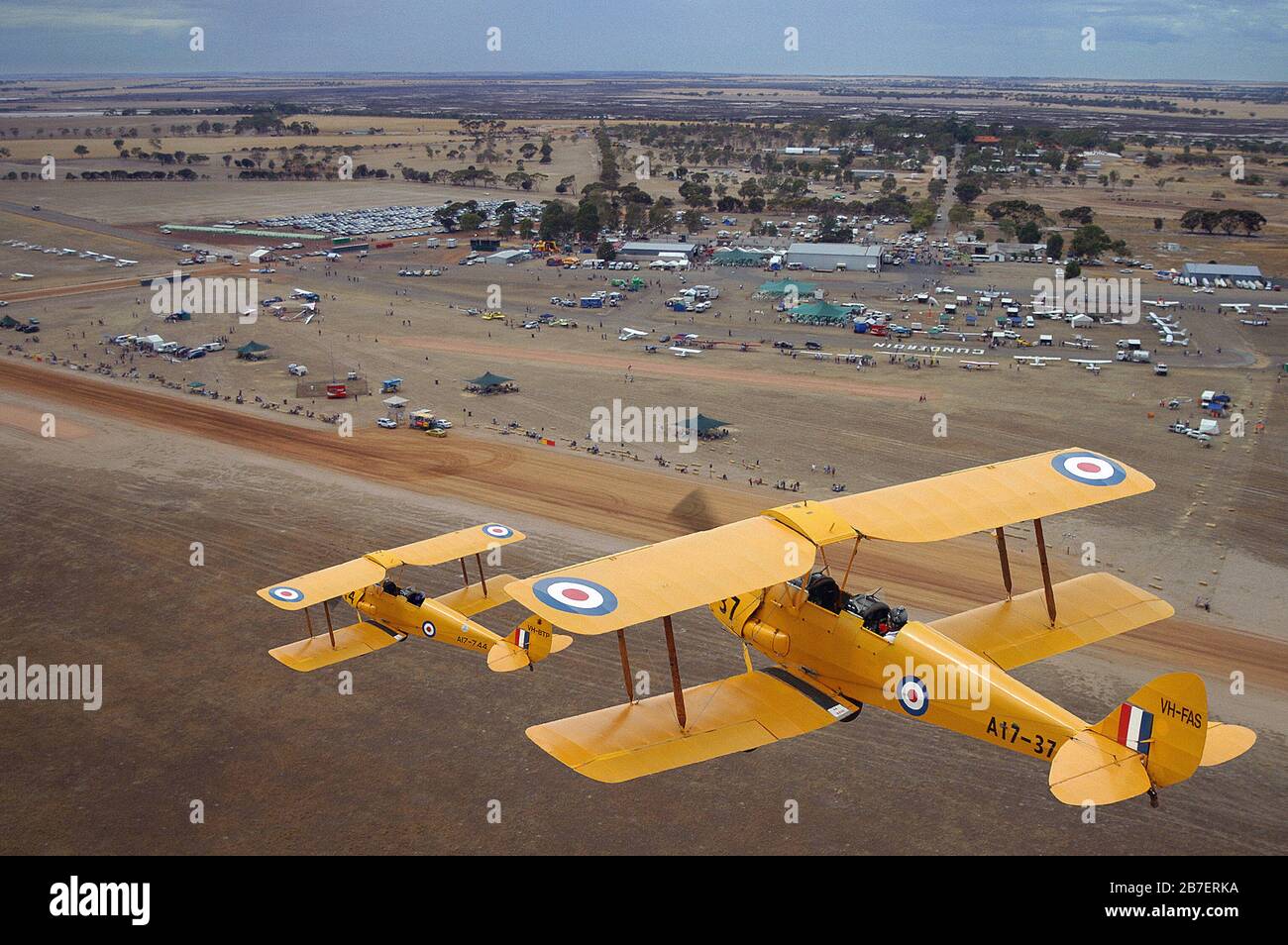 An air to air shot of two yellow 1940's DH.84 Tiger Moth trainers at an ...