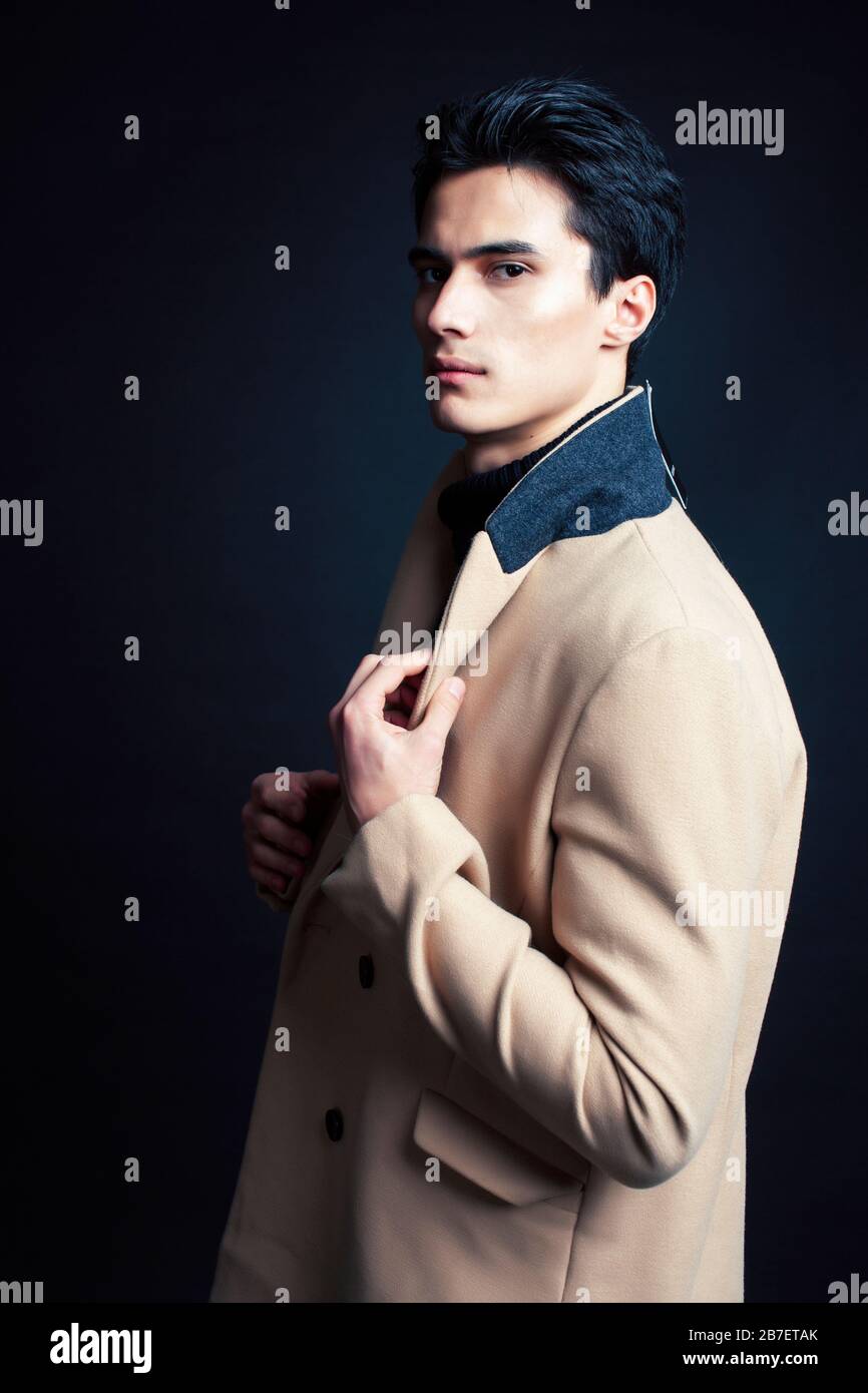 handsome asian fashion looking man posing in studio on black background ...
