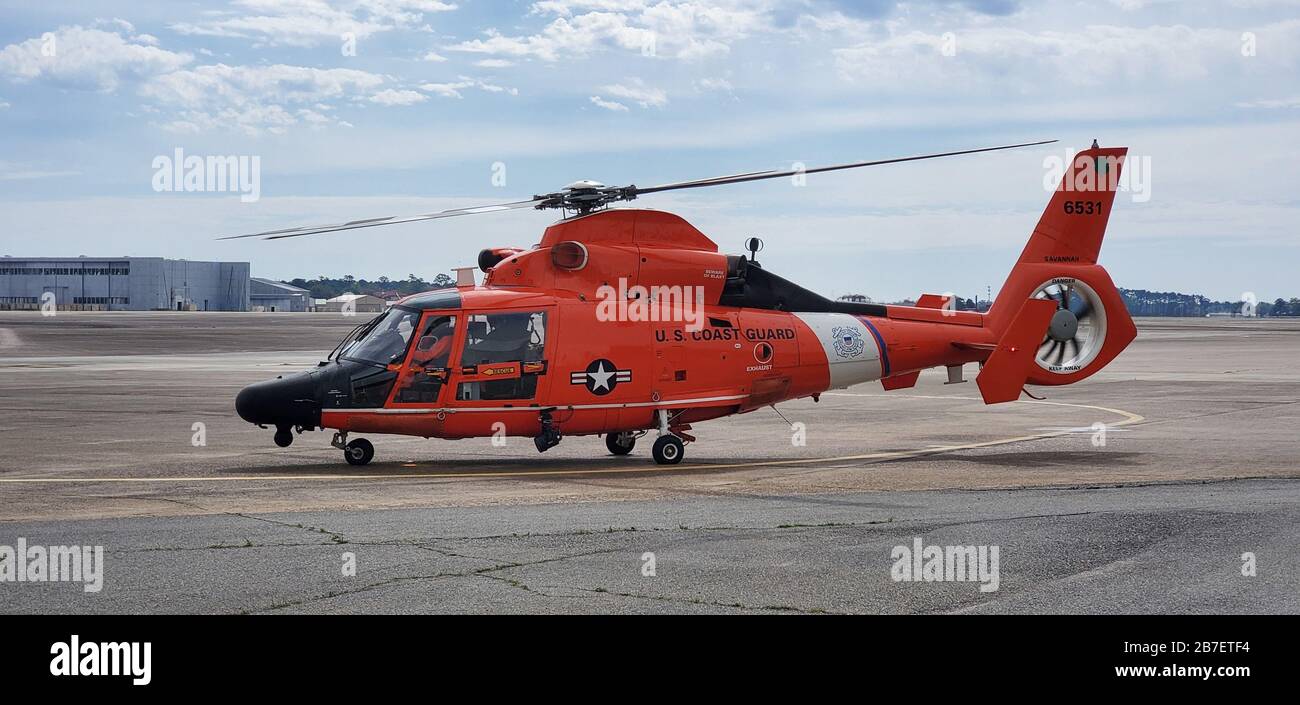 U.S. Coast Guardsmen aboard an Air Station Savannah, Georgia, MH-65D ...