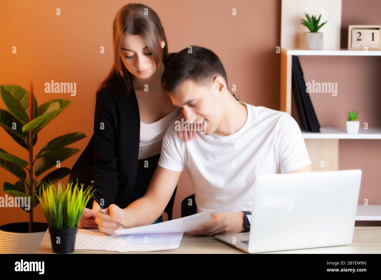 Loving couple working successfully together on their own business in ...