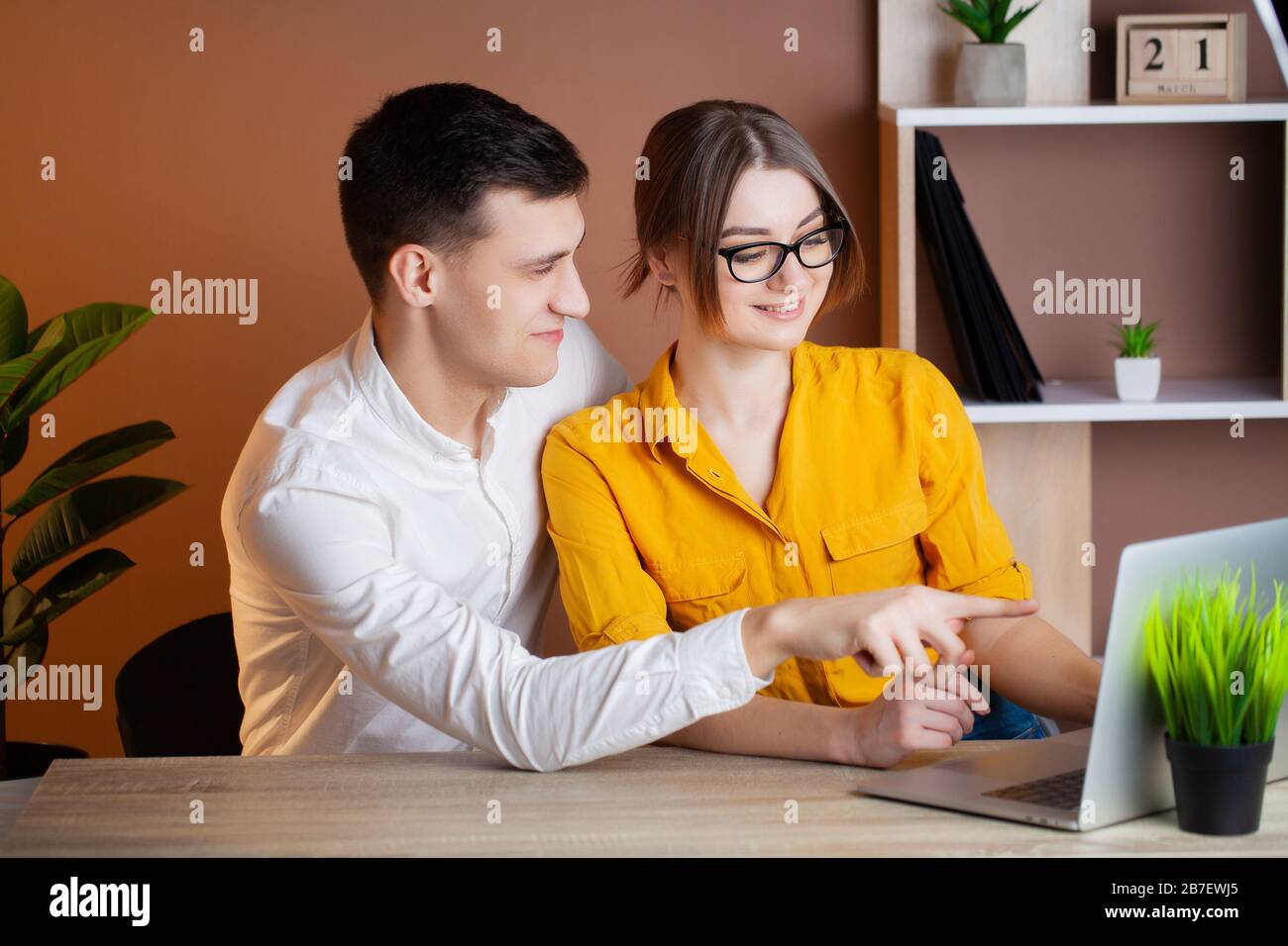 Loving couple working successfully together on their own business in ...