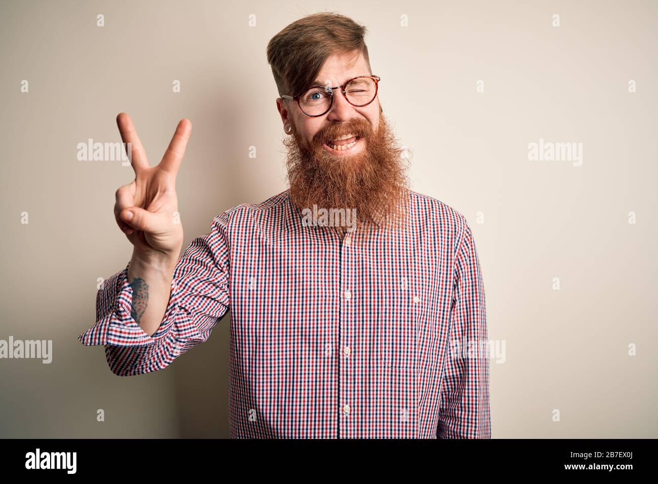 Handsome Irish redhead business man with beard wearing glasses over ...