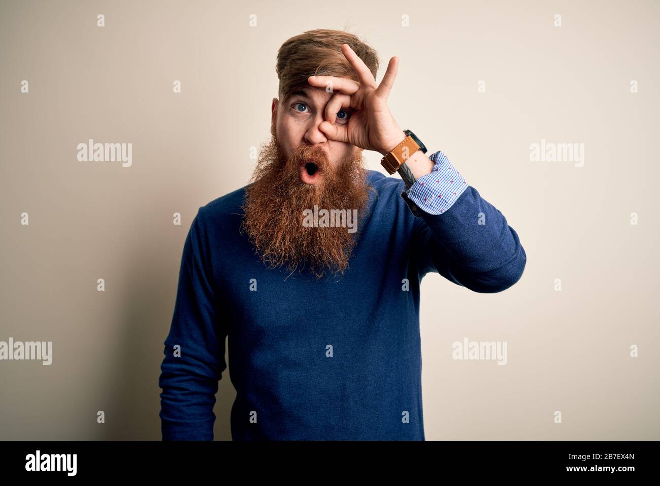 Handsome Irish redhead business man with beard standing over isolated ...