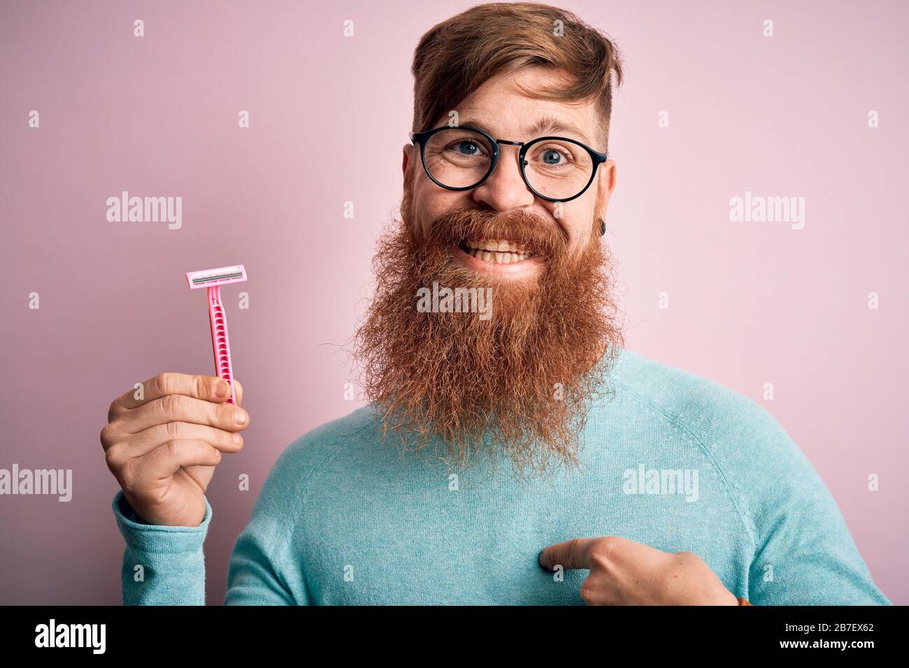 Redhead Irish man with beard holding beauty razor for shaving and skin ...