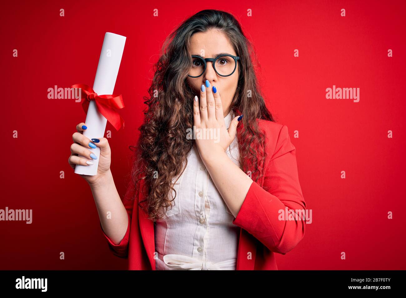 Young beautiful woman with curly hair holding university diploma degree ...
