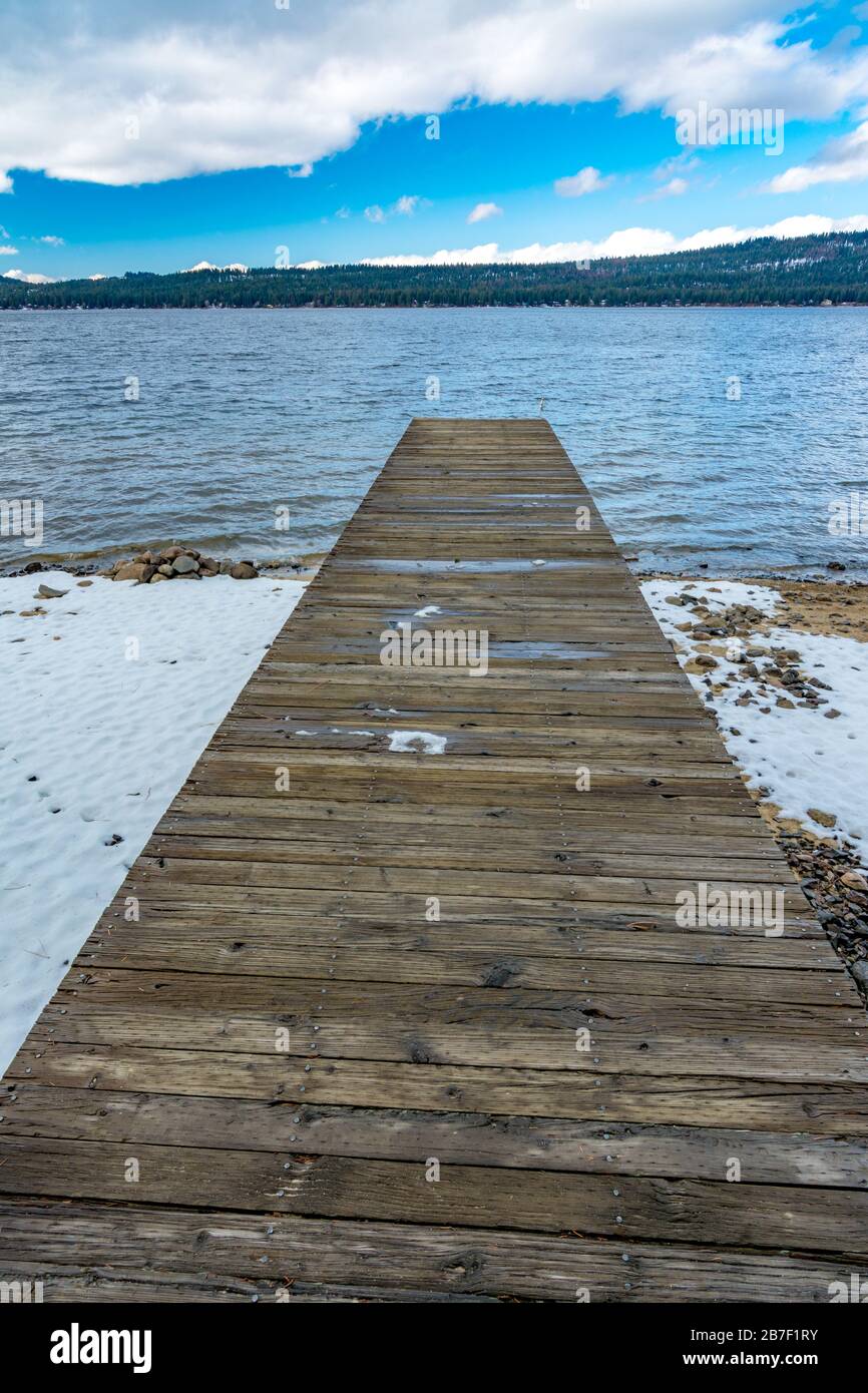 Cold water lake with a dock stretching over the water Stock Photo - Alamy