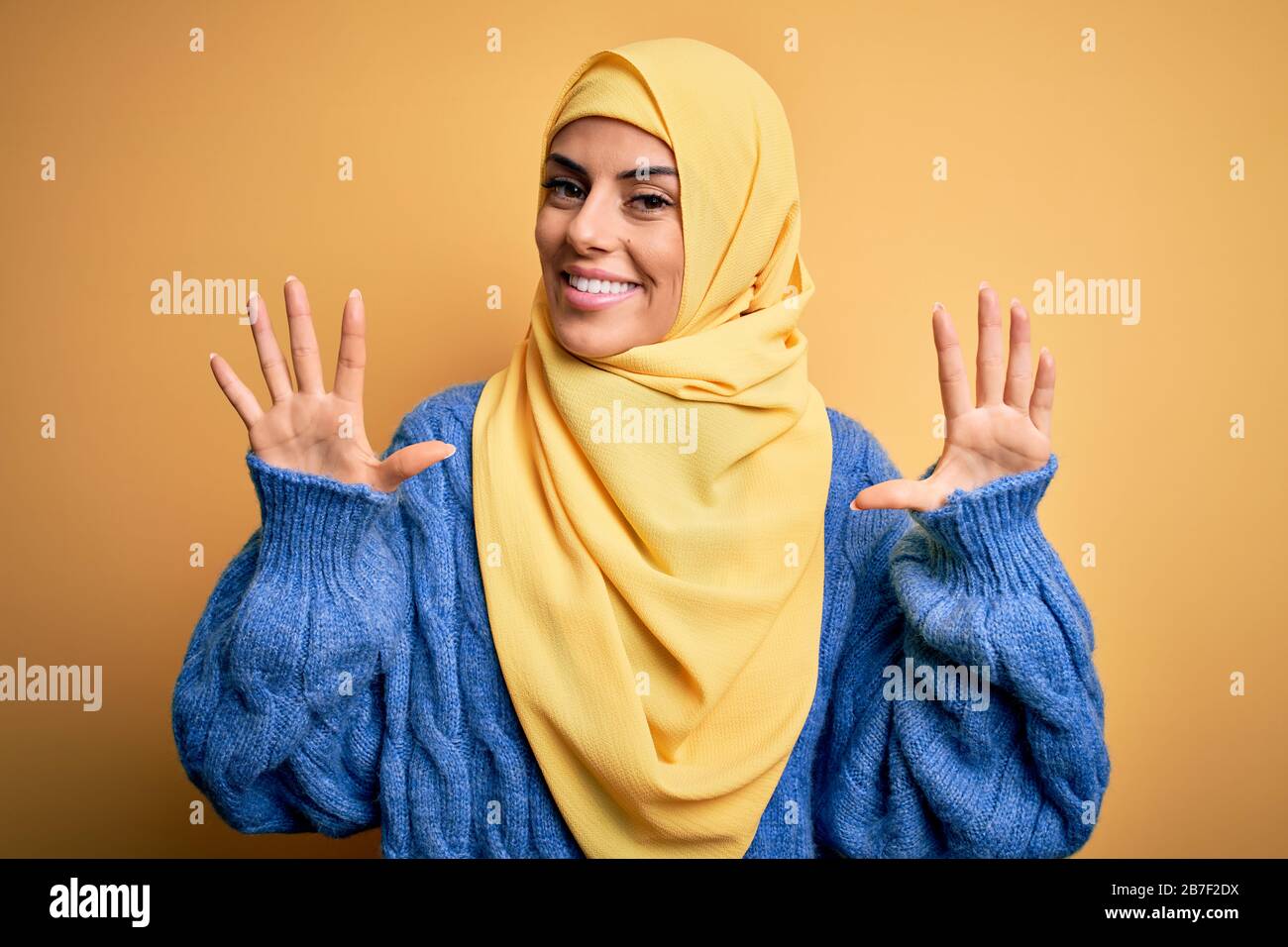 Young beautiful brunette muslim woman wearing arab hijab over isolated ...