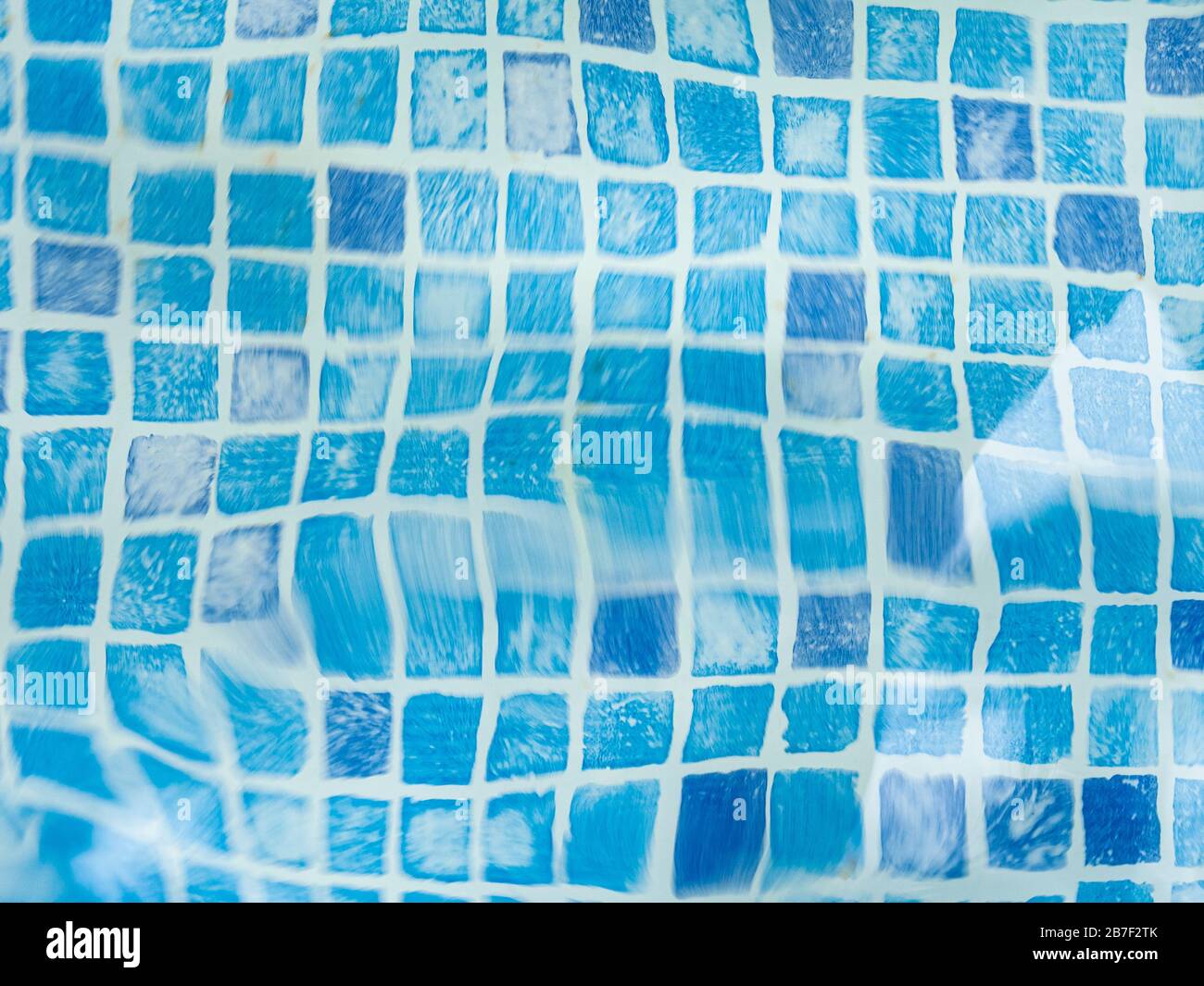 The light reflected on the top of the water surface of the pool lined ...